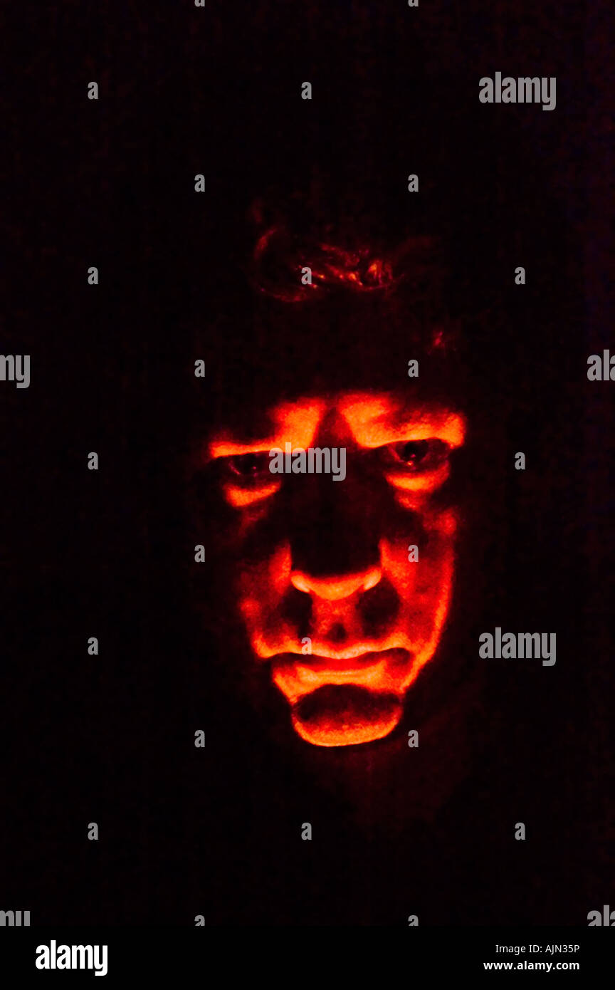 middle aged man lit by torch spooky halloween ghostly effect at night ...