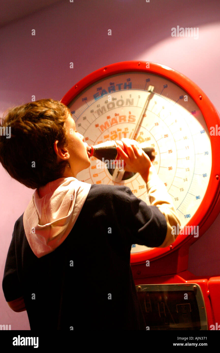 BOY ON WEIGHING SCALES Stock Photo - Alamy