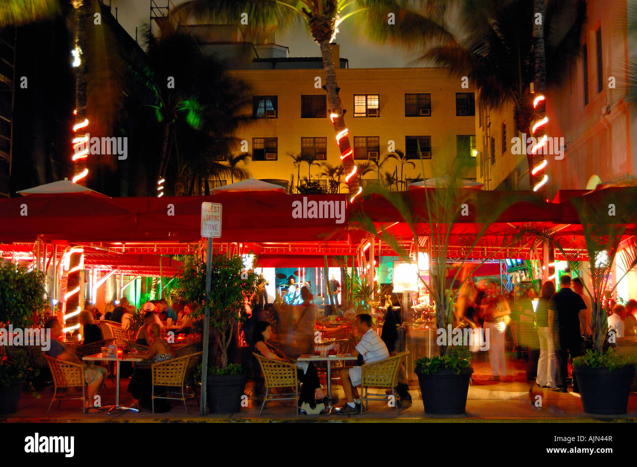 hotel restaurant buildings and people eating dining at night on ocean ...