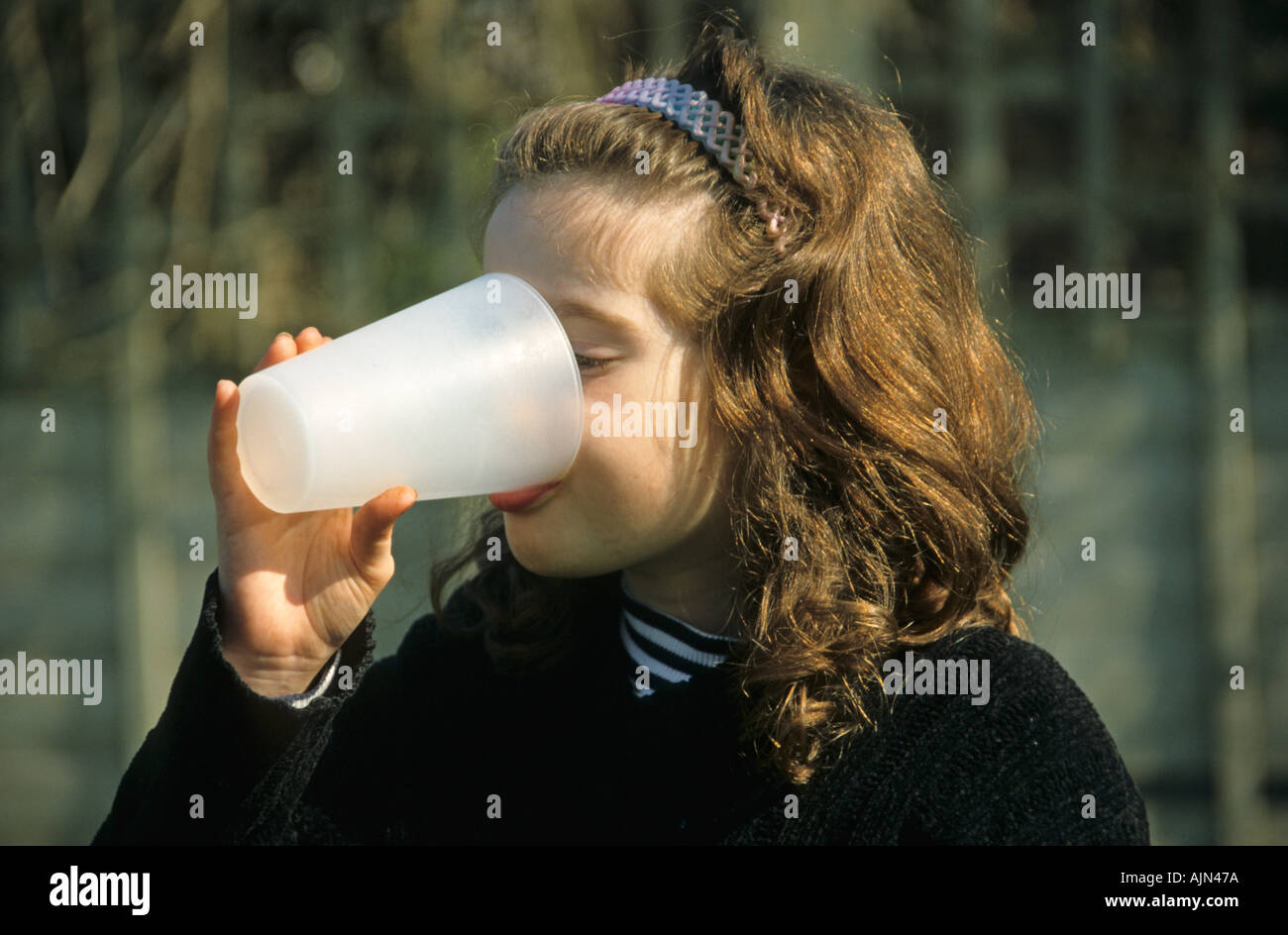 girl having a drink from a beaker Stock Photo - Alamy