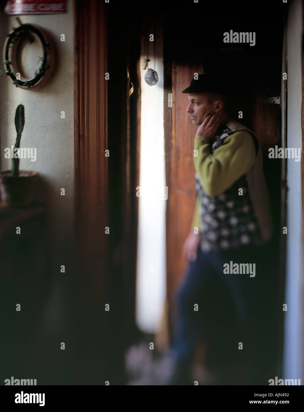Man looking out of door Stock Photo - Alamy