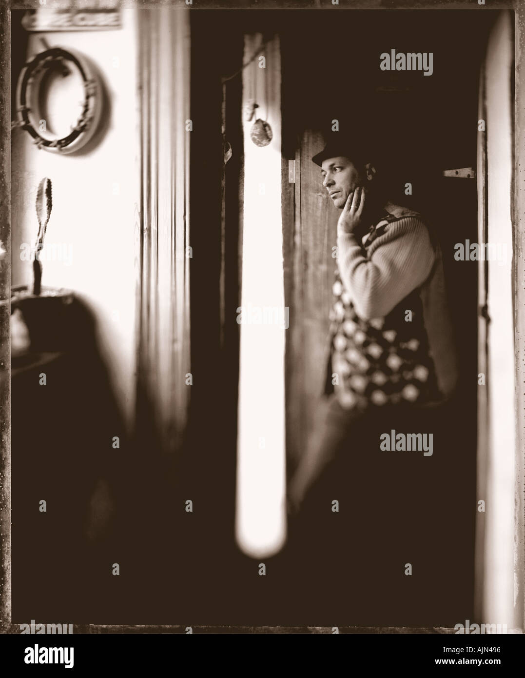 Man looking out of door Stock Photo - Alamy
