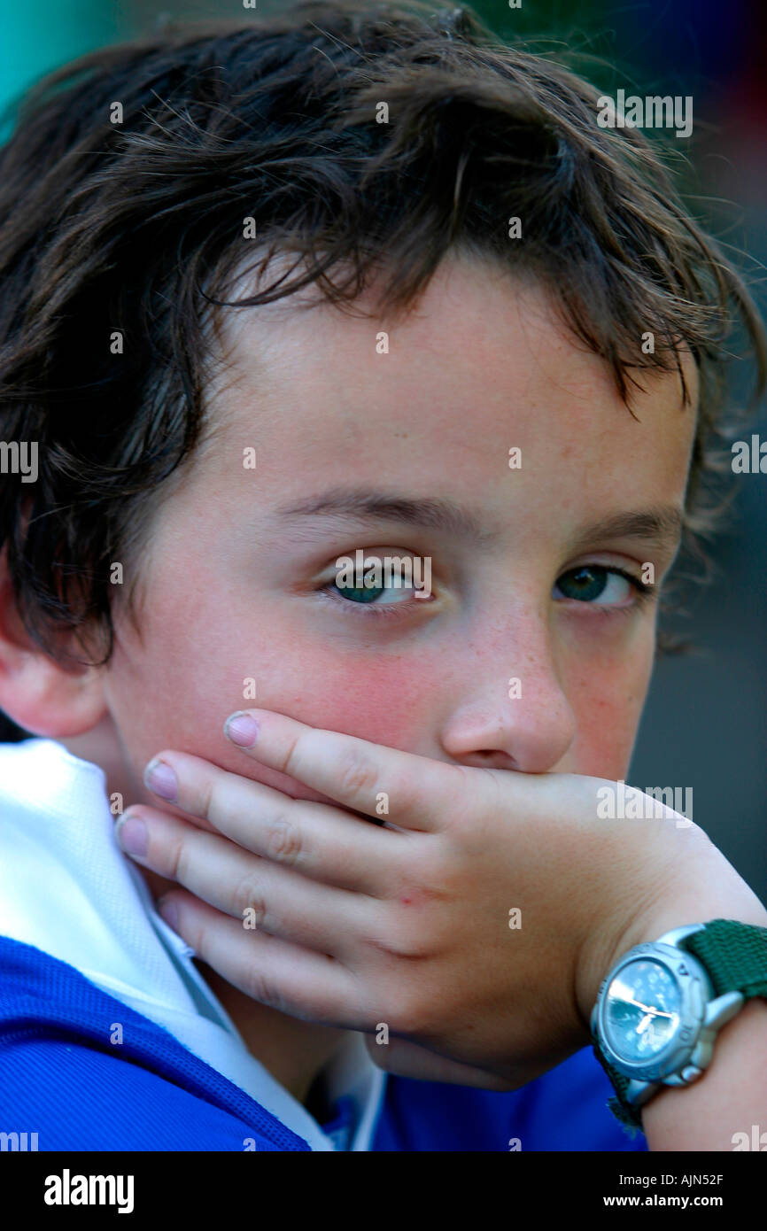 BOY WITH HAND COVERING FACE Stock Photo - Alamy