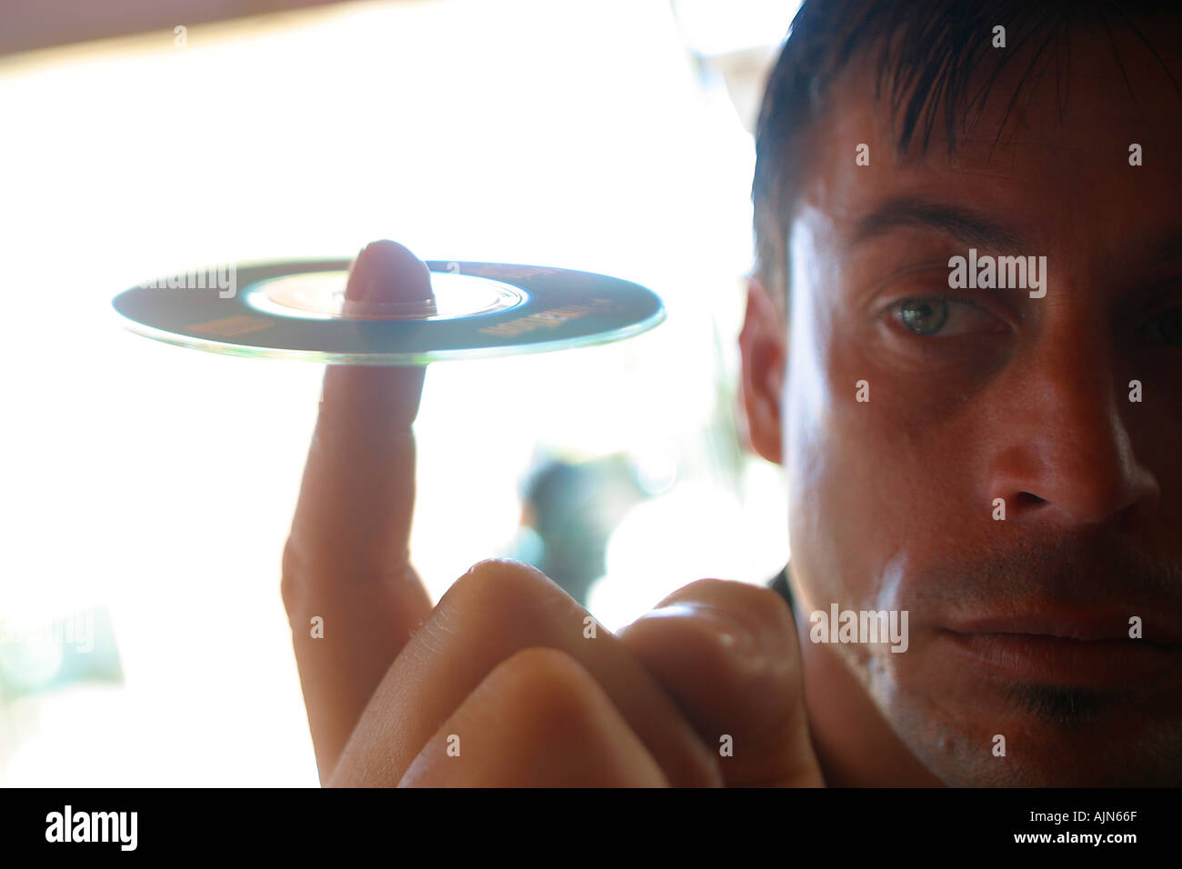 MAN WITH CD DISC Stock Photo - Alamy
