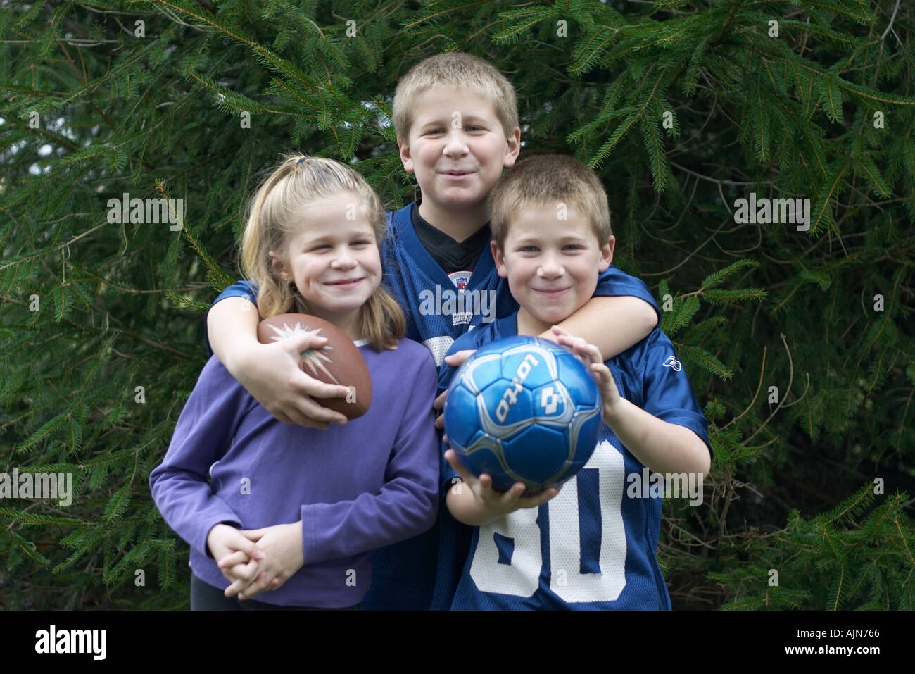 Three Children posing Stock Photo - Alamy