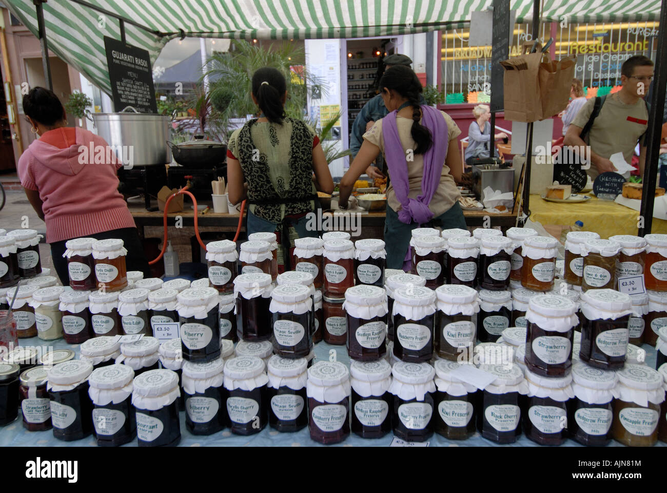 London UK Broadway market Hackney Selling jam with back view of Asian ...