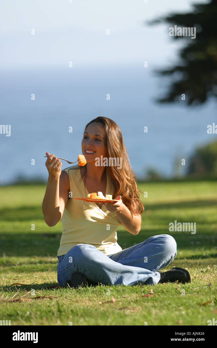 Woman with fruit seated hi-res stock photography and images - Alamy