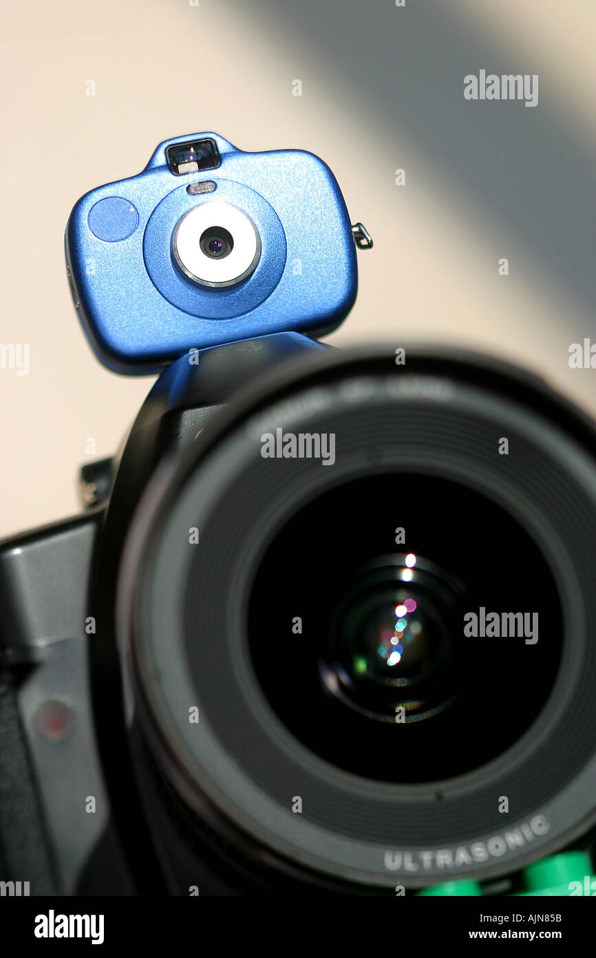 mini digital camera compared to standard size camera Stock Photo - Alamy