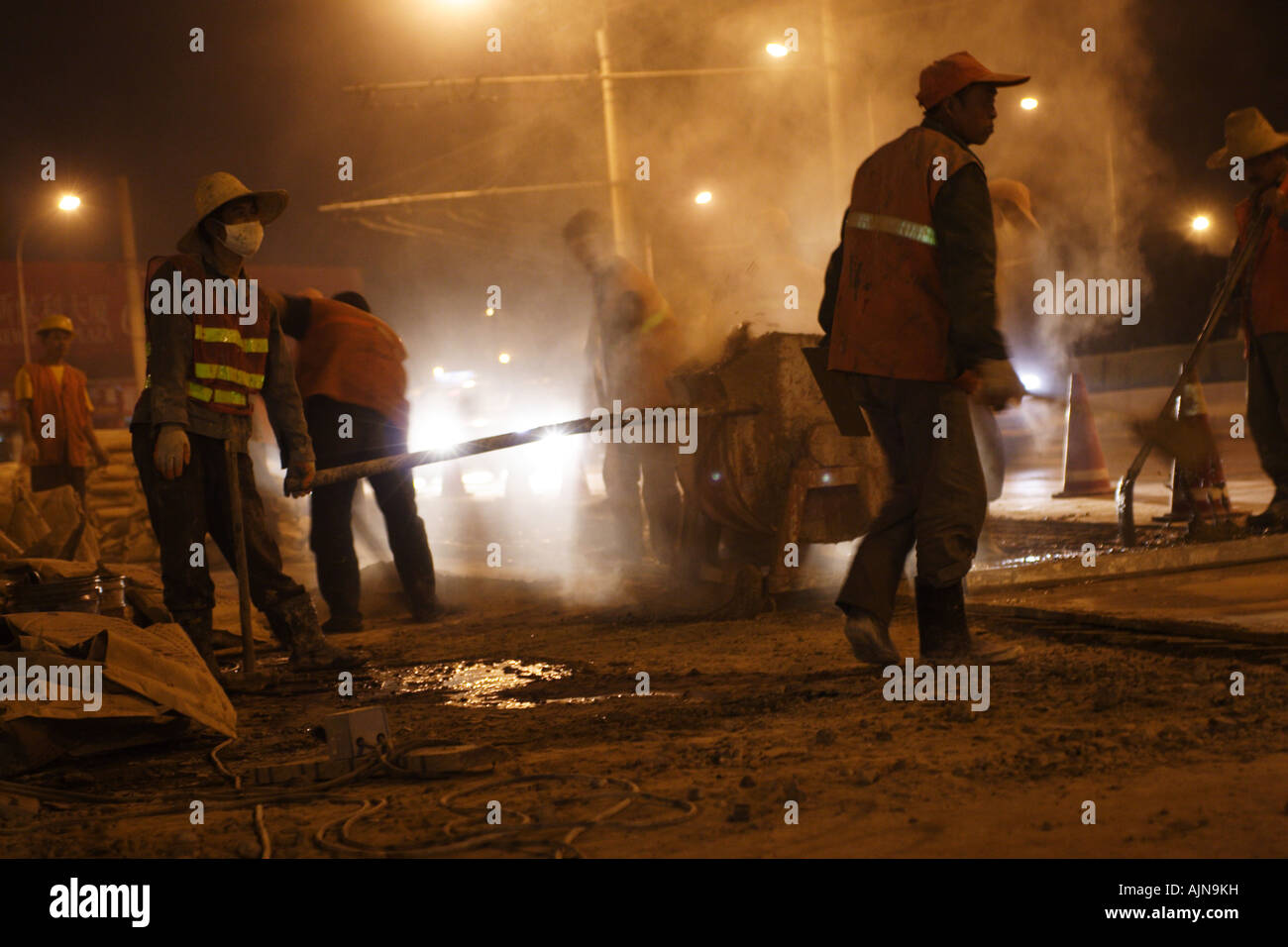 A gang of men work on a road in central Beijing, making improvements at ...