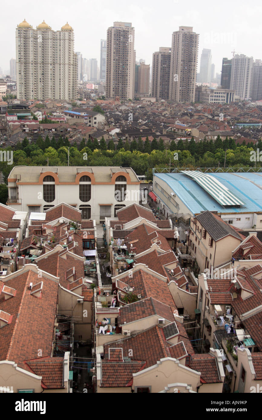 Highrise buildings tower above older low rise buildings in Shanghai ...