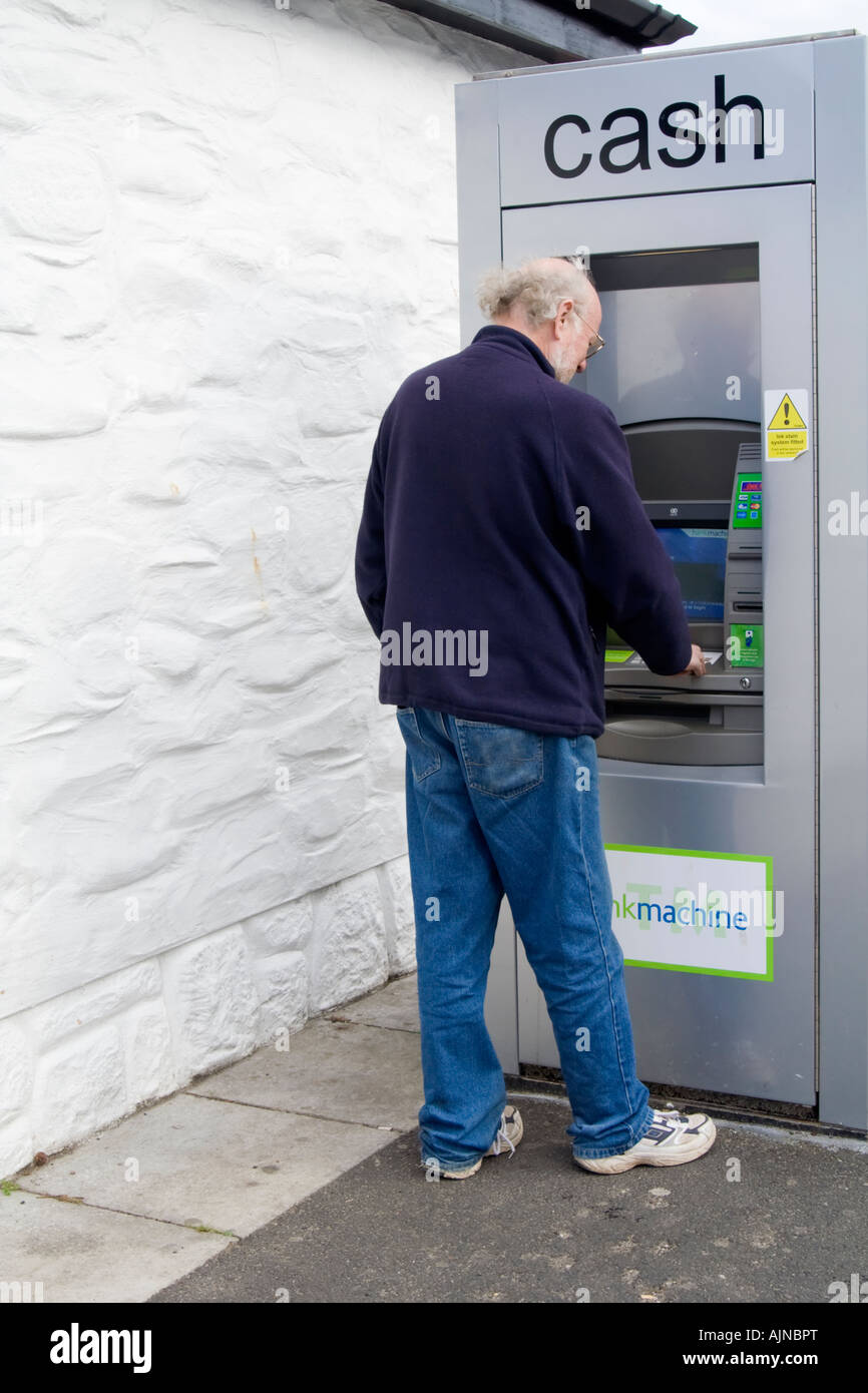 Man using a cash machine Stock Photo - Alamy