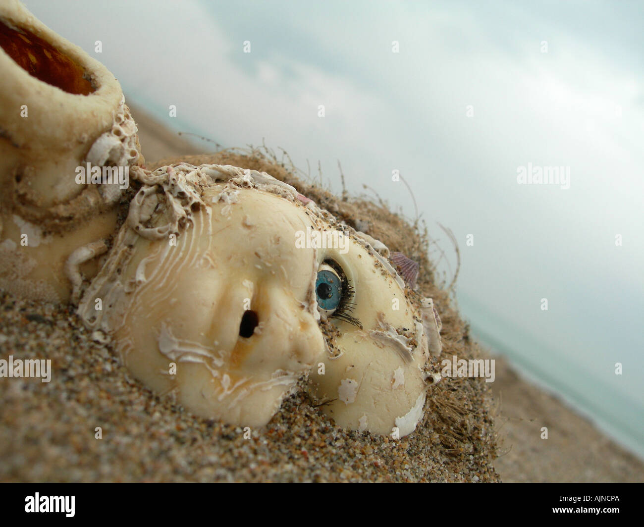 doll toy lost dead death symbol object sea time Stock Photo - Alamy