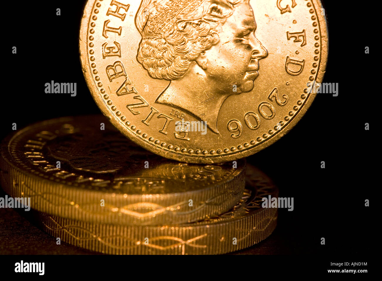One Pound British coins on black background Stock Photo - Alamy