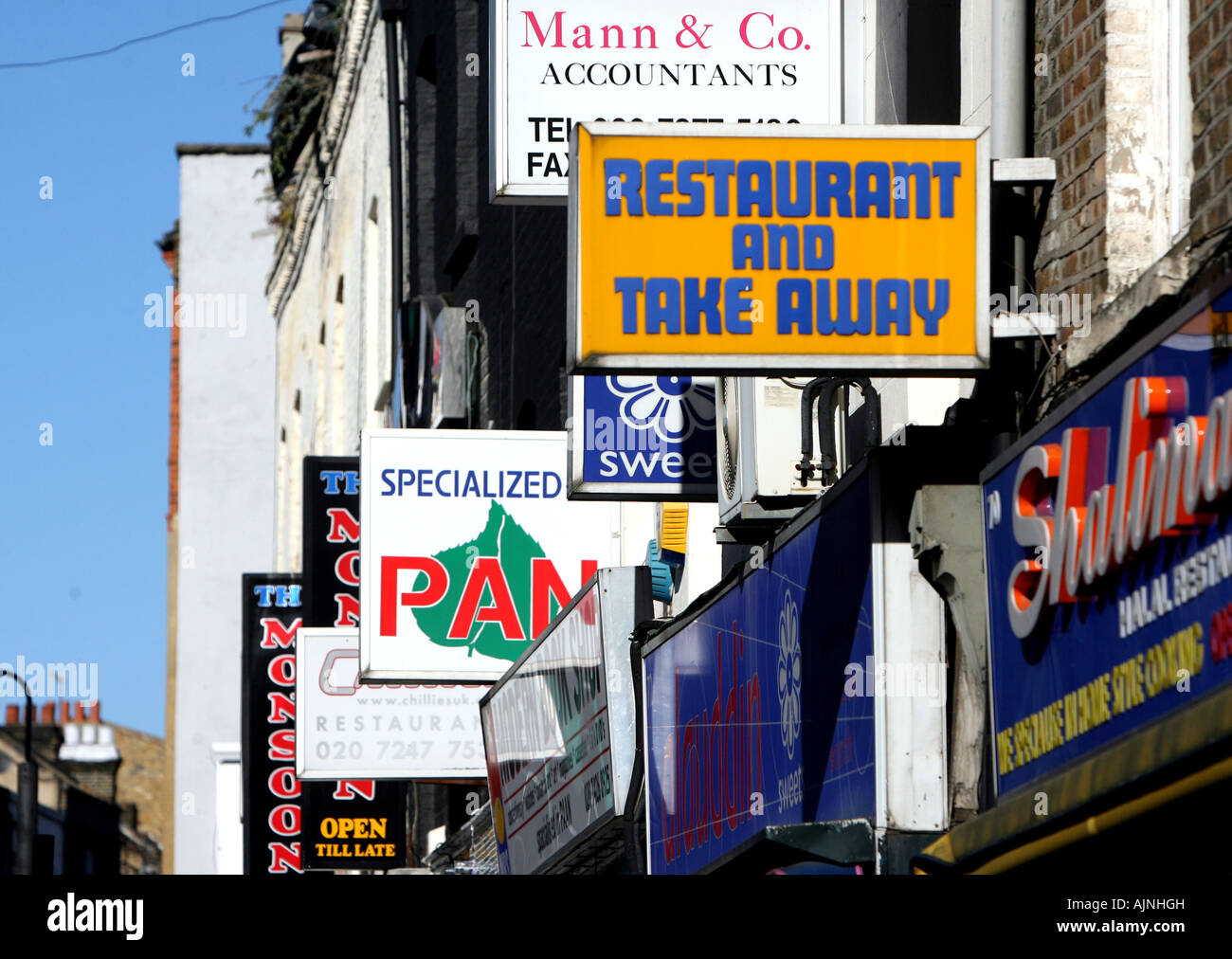 Signs for Curry Houses Accountants and Travel Companies hang in Brick ...