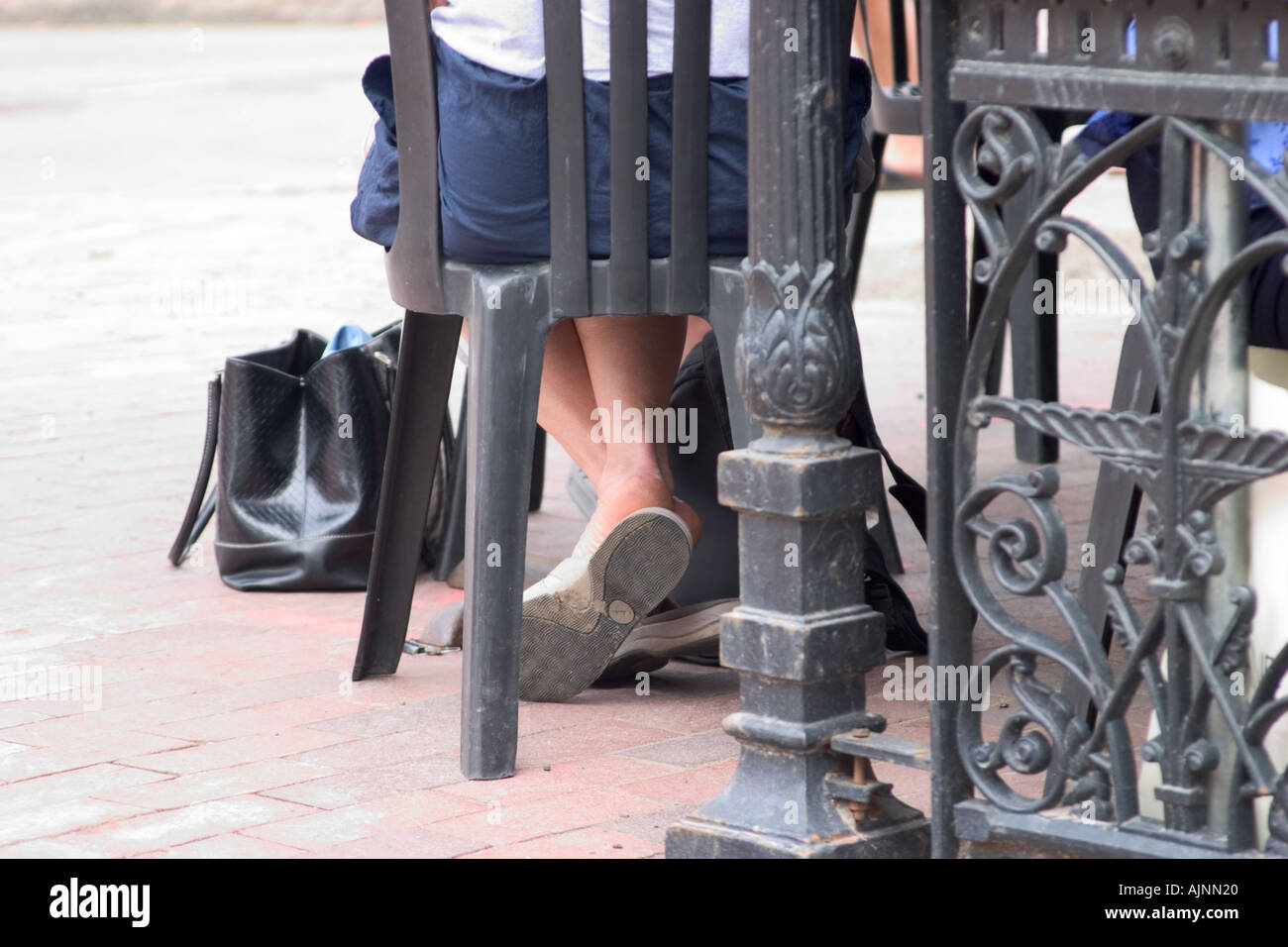 Legs and feet of a woman who is sitting in a chair Stock Photo - Alamy