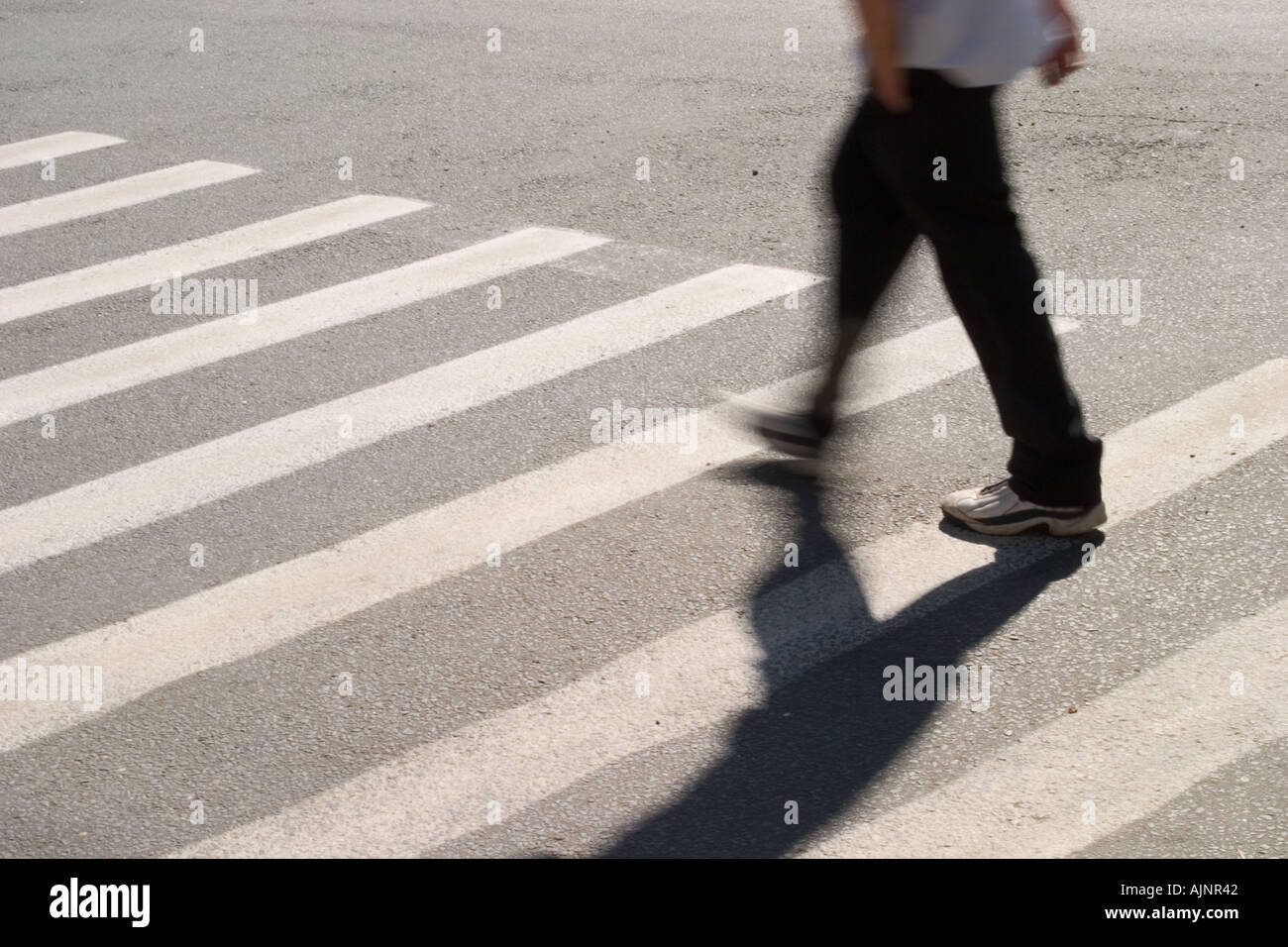 Close up of legs and feet crossing a street in the crosswalk Stock ...