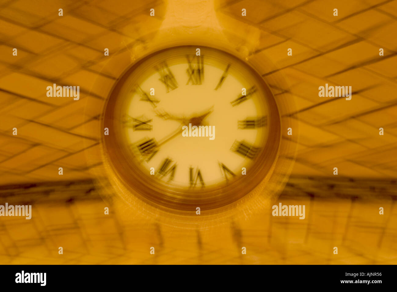 Clock hanging from an office building lobby Stock Photo - Alamy
