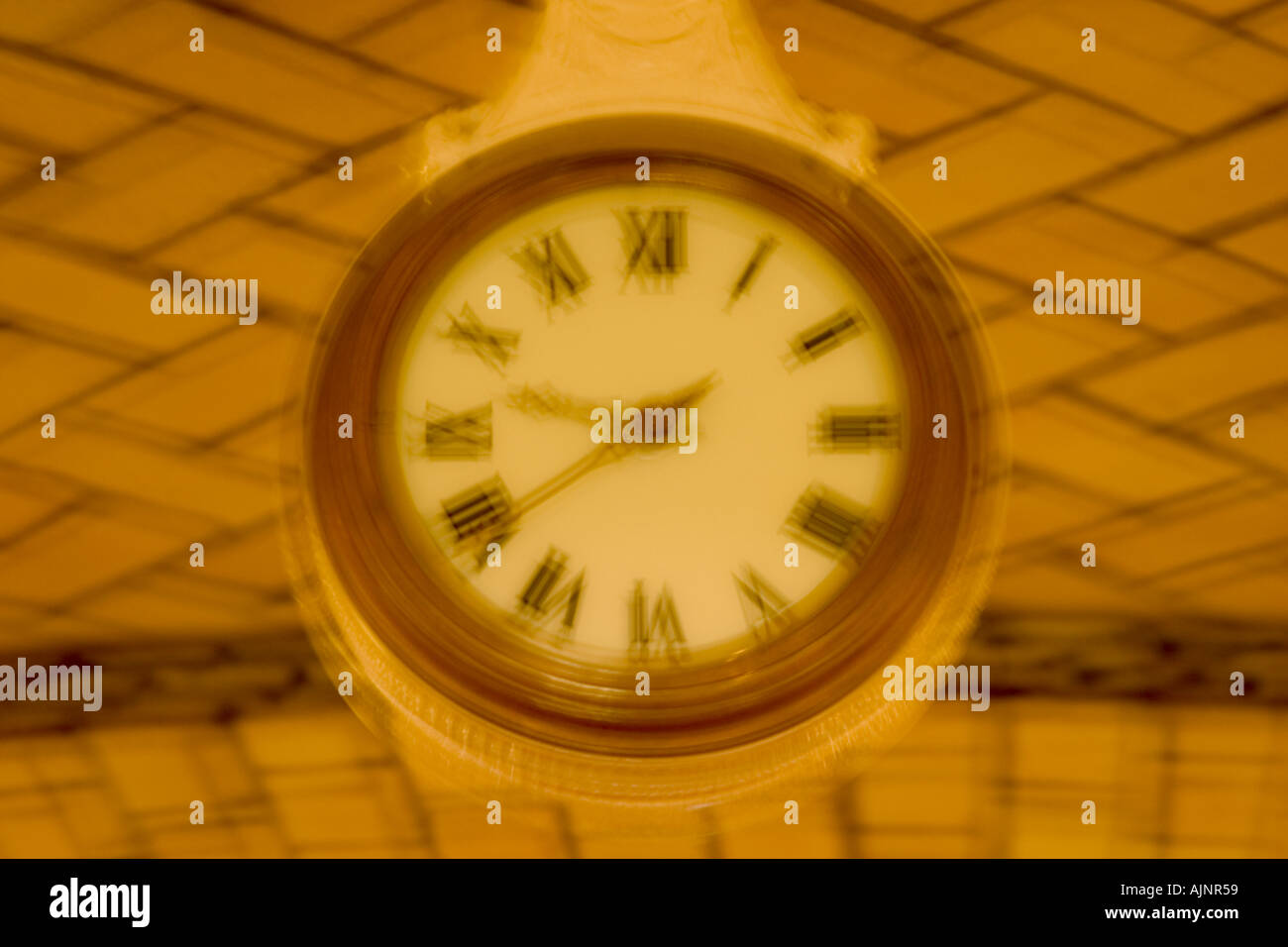Clock hanging from an office building lobby Stock Photo - Alamy