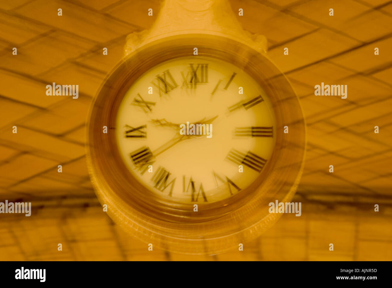 Clock hanging from an office building lobby Stock Photo - Alamy
