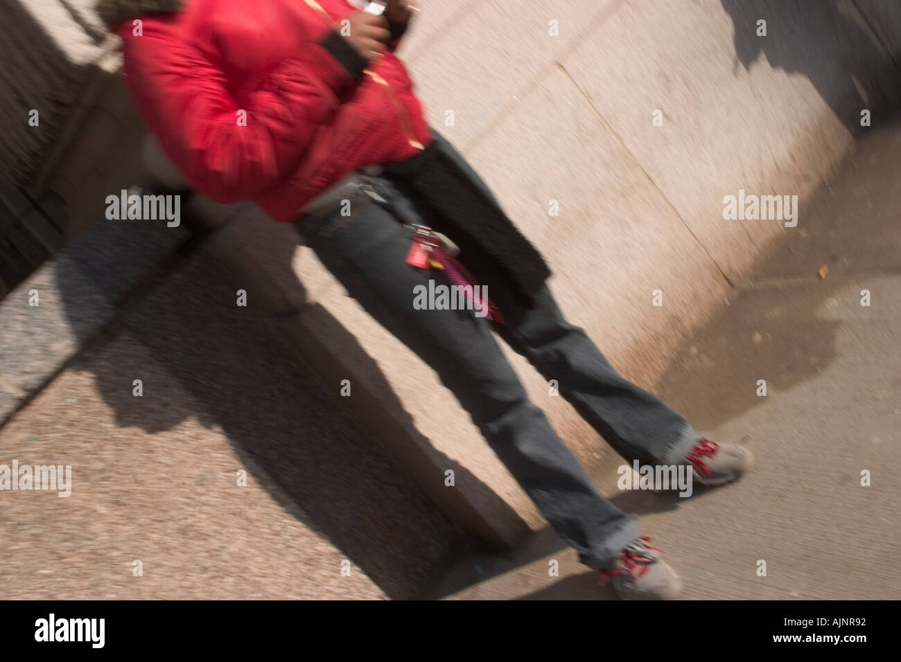Person from the chest down standing outside against a wall Stock Photo ...