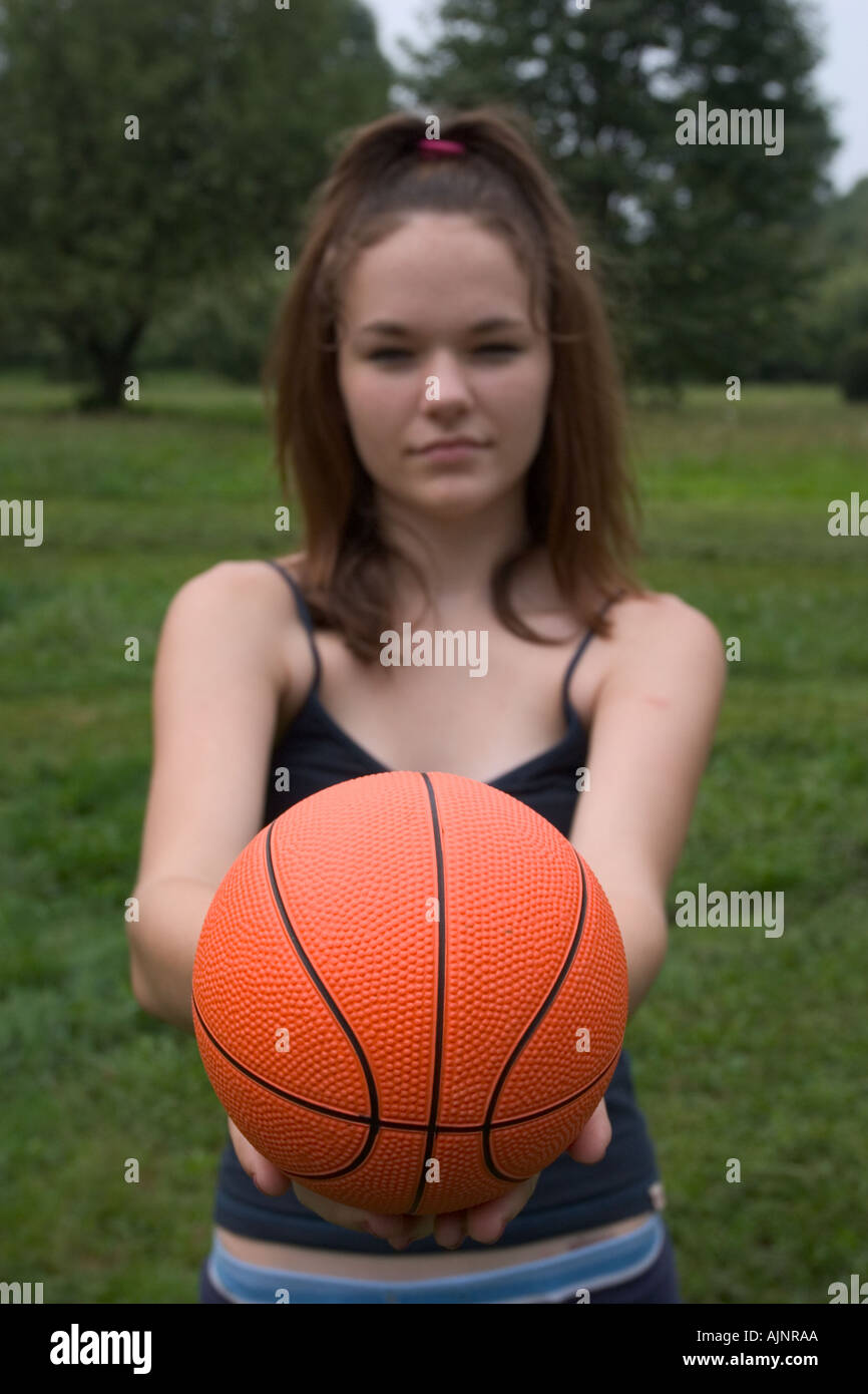 Teen girl holding a basketball Model Released Stock Photo - Alamy
