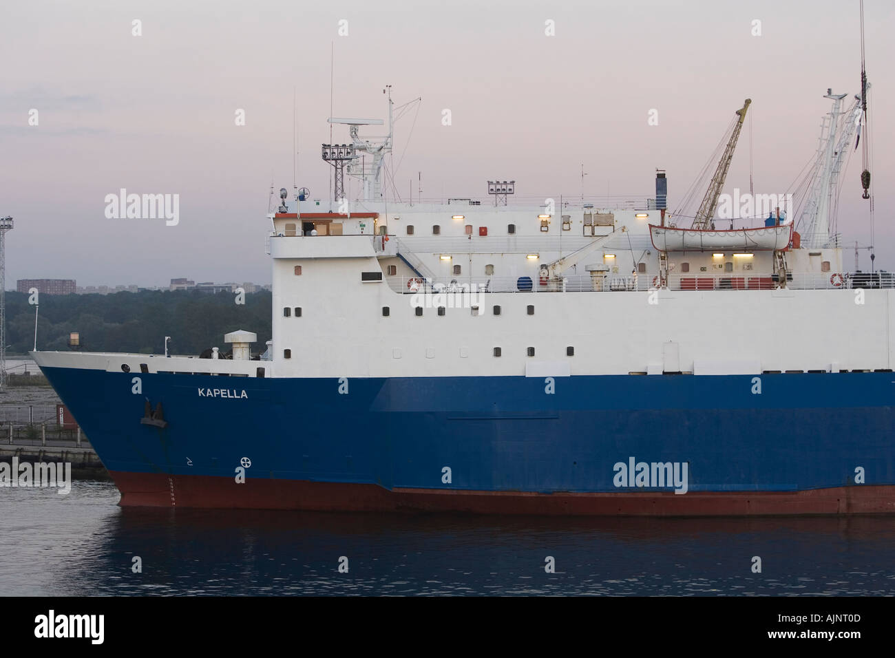 Side profile of an industrial ship moving past a dock Stock Photo - Alamy