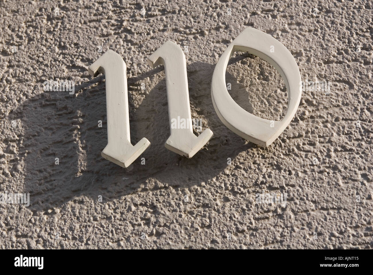 Number 110 mounted on a wall Stock Photo - Alamy