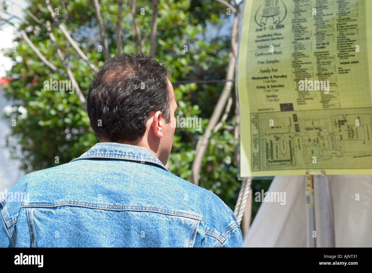 Man looking at a map Stock Photo - Alamy