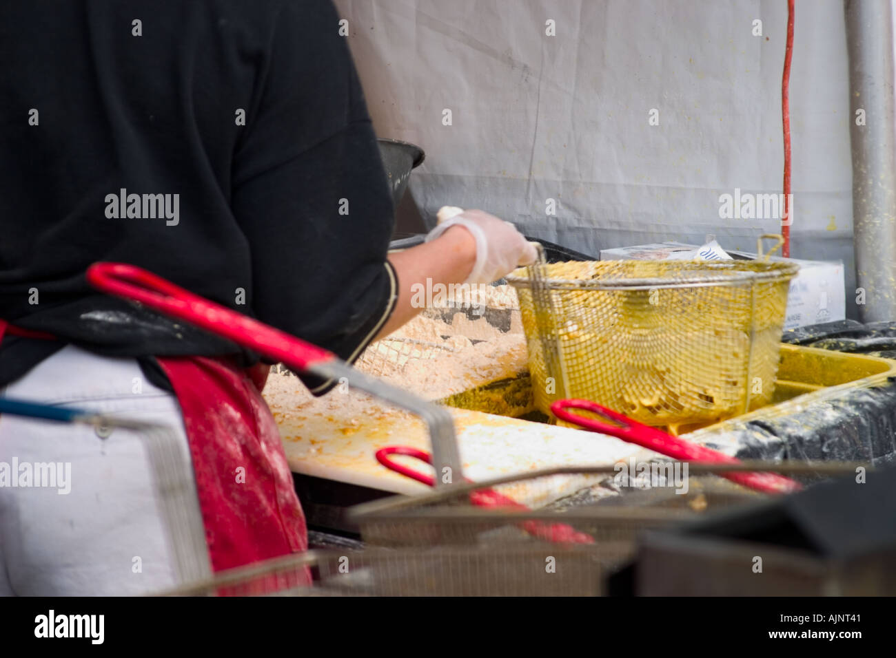 Restaurant worker preparing fried food at an outdoor festival Stock ...