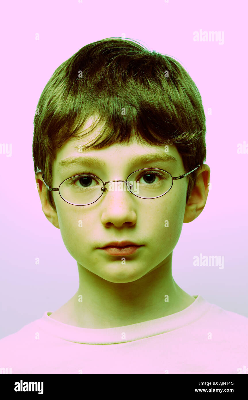 Young boy staring at the camera cross processed Stock Photo - Alamy