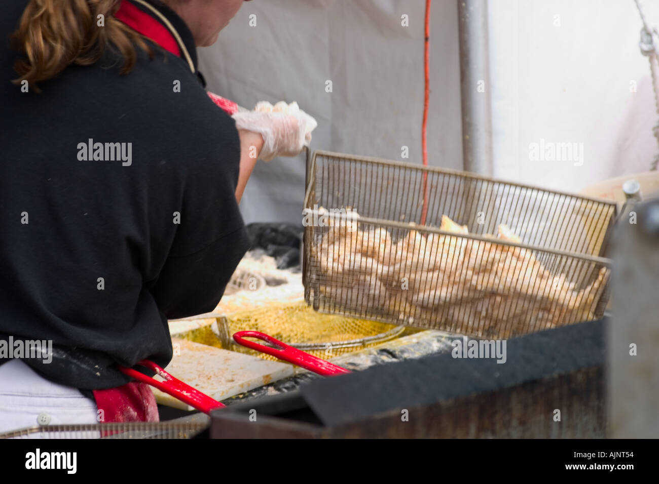 Restaurant worker preparing fried food at an outdoor festival Stock ...