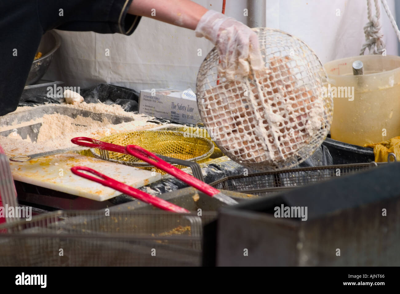 Restaurant worker preparing fried food at an outdoor festival Stock ...