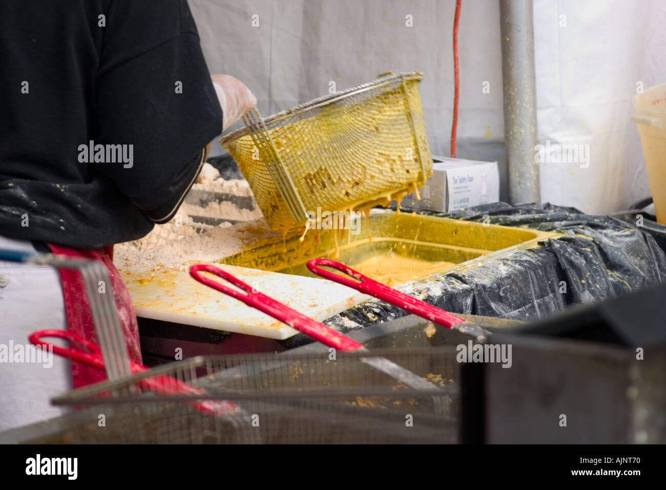 Restaurant worker preparing fried food at an outdoor festival Stock ...