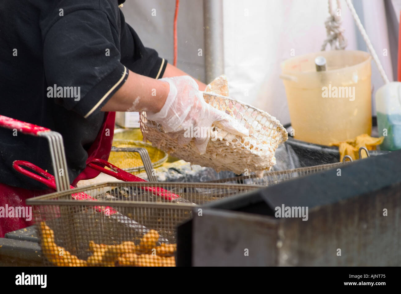 Restaurant worker preparing fried food at an outdoor festival Stock ...