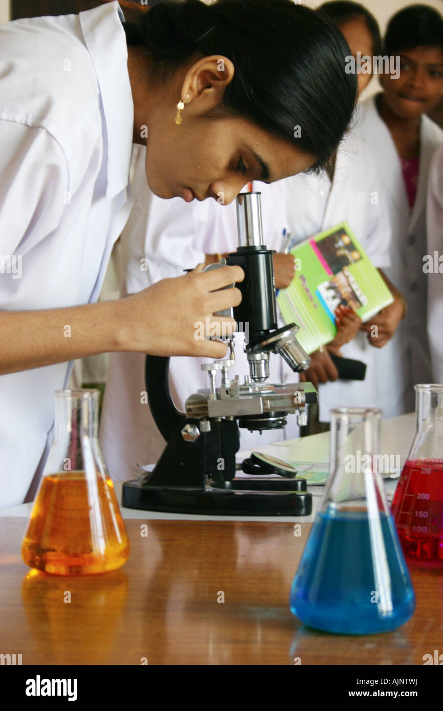 A young woman observing a microscope Stock Photo - Alamy