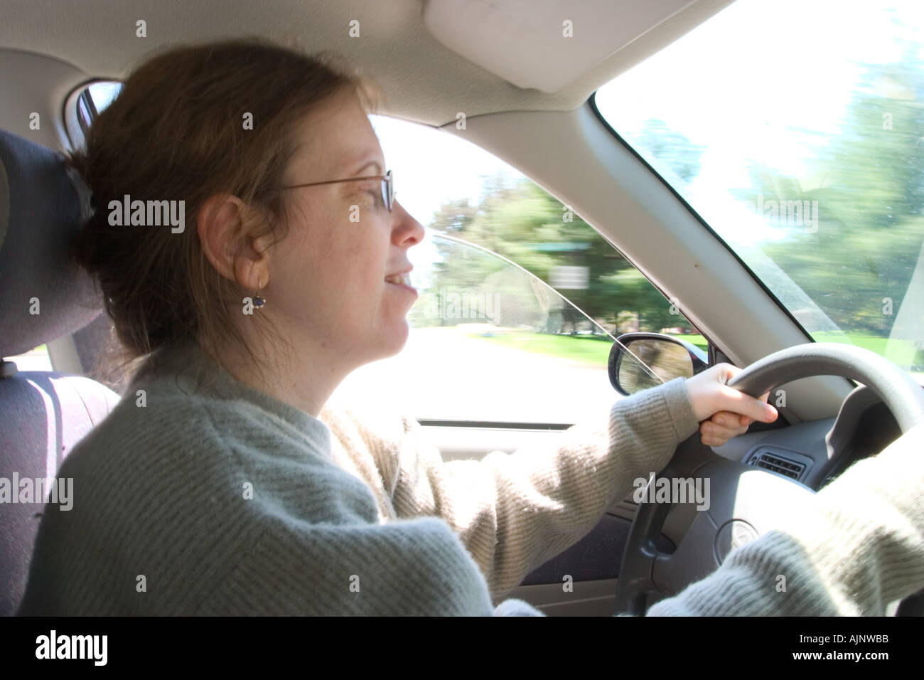 Young woman wearing glasses driving hi-res stock photography and images ...
