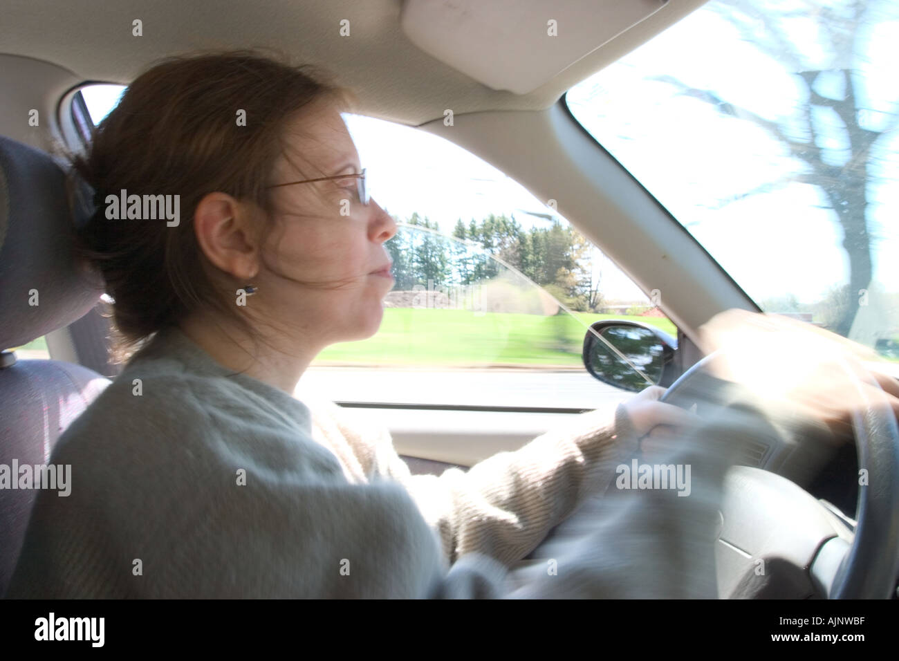 Woman wearing glasses and driving hi-res stock photography and images ...