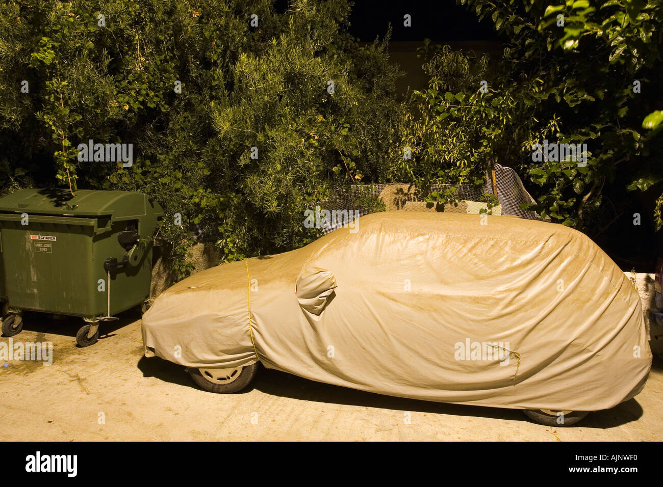 Side profile of a covered car Stock Photo - Alamy