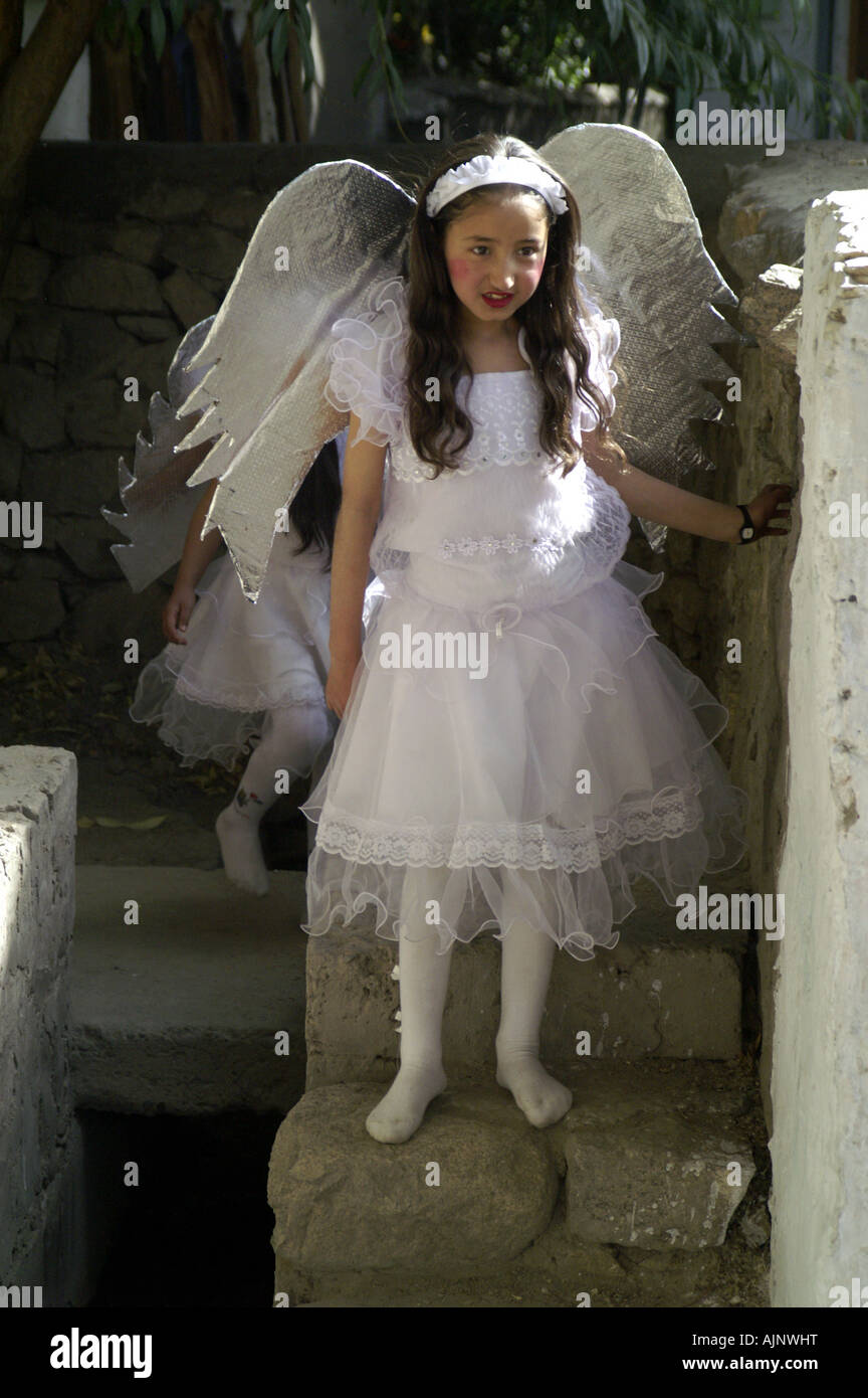 Girl child angel carnival mask white robe standing in Leh, Ladakh ...