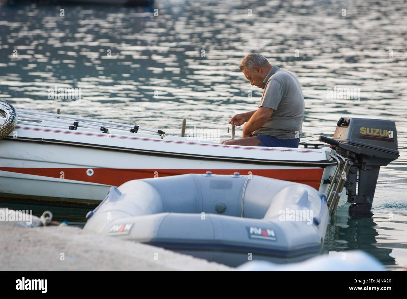 Side profile of a mature man sitting in a motorboat Stock Photo - Alamy