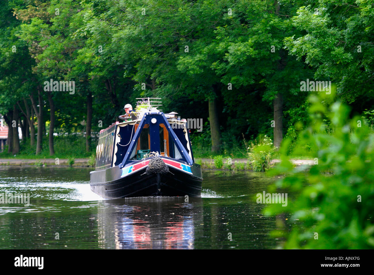 Nottingham Beeston canal, canal barge motoring towards castle lock ...