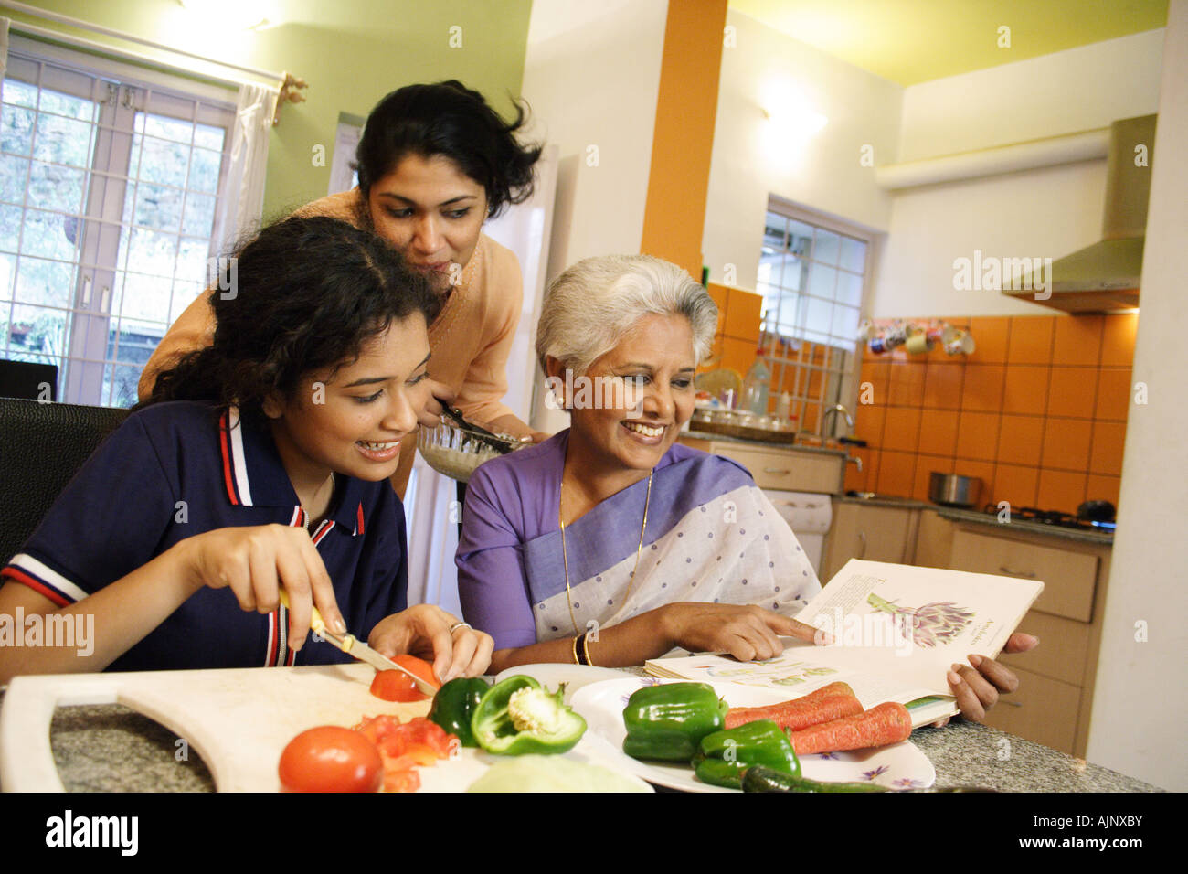 A three generations family preparing for a meal Stock Photo - Alamy