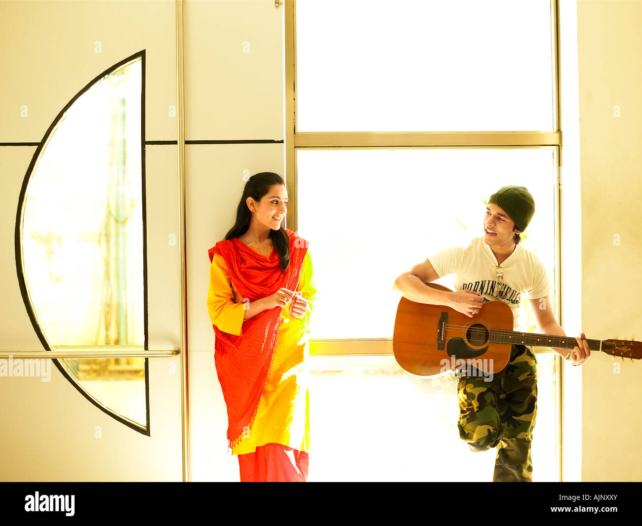 A young man serenading to a woman Stock Photo - Alamy