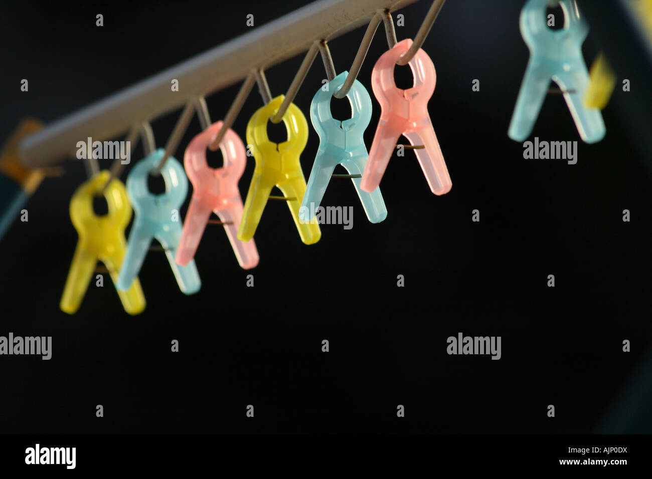 row of colorful clothes pegs Stock Photo - Alamy