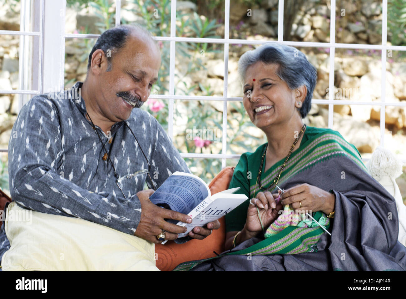 A middle aged couple sharing a joke Stock Photo - Alamy