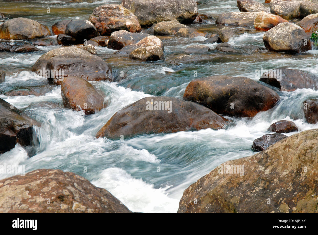 water flowing through rocks in a river Stock Photo - Alamy