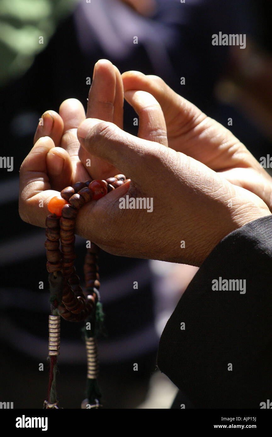 Holy tibetan buddhist gesture mudra palms and fingers and beads, prayer ...