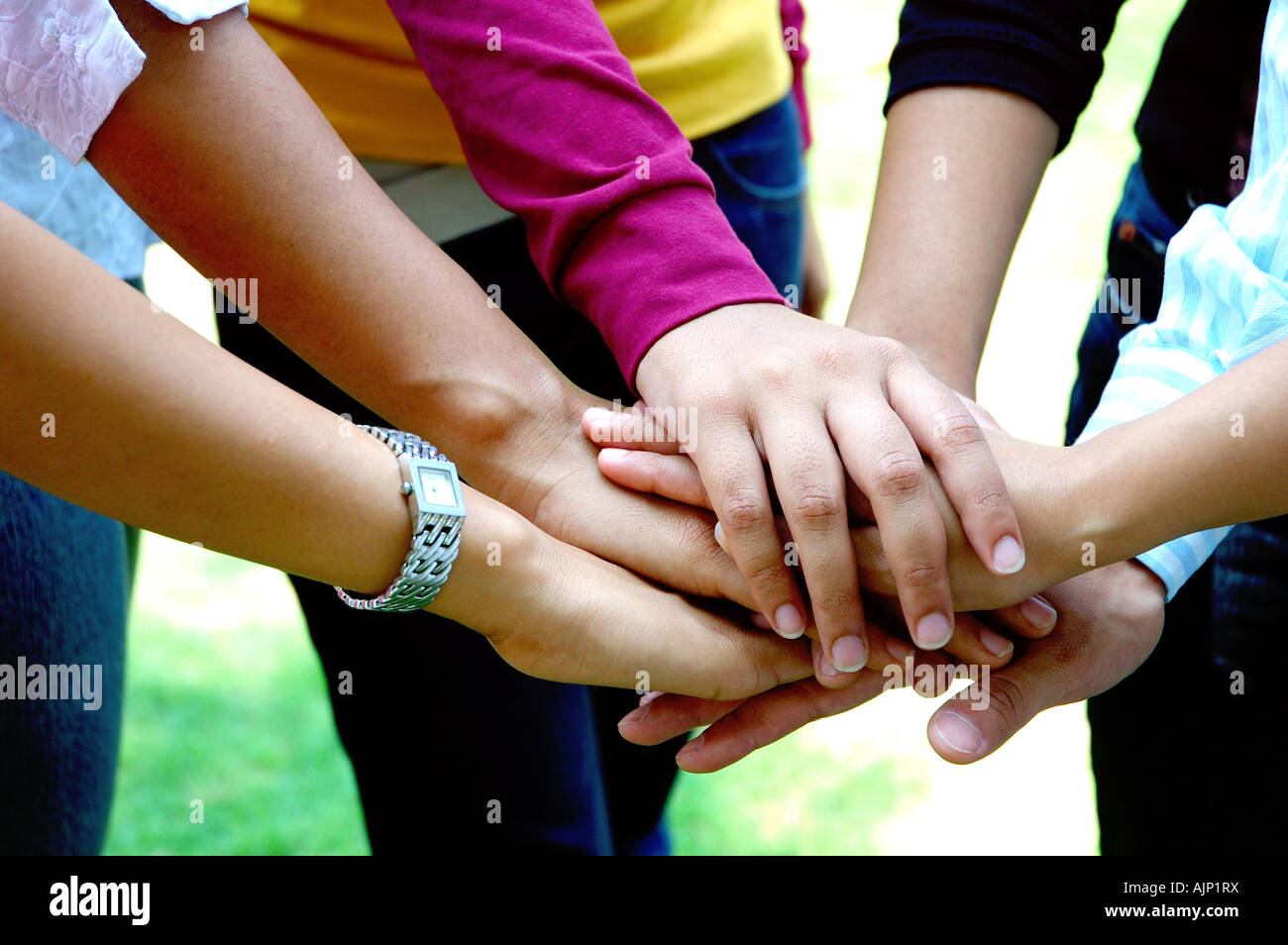 Group of people stacking hands Stock Photo - Alamy