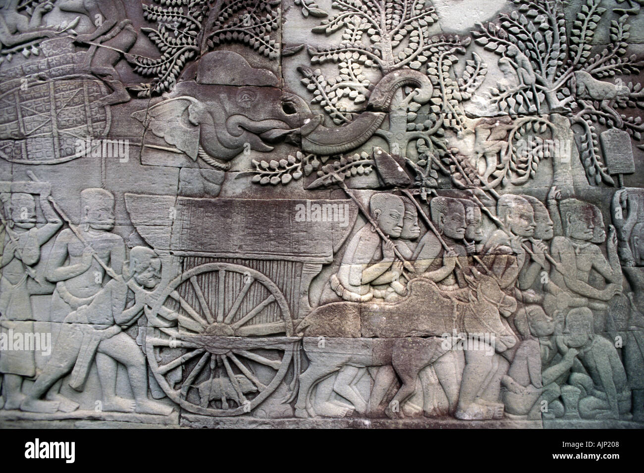 Bas Relief with elephant people and cart carved onto walls of the Bayon ...