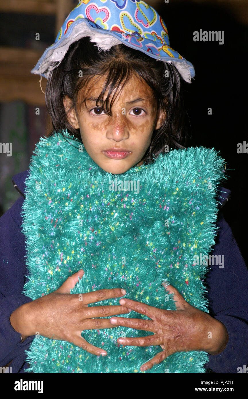 One unhappy sad indian young girl standing holding fluffy cloth ...